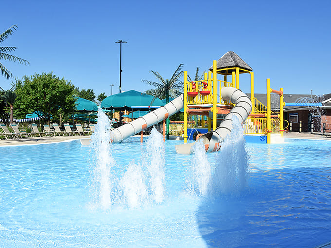 The perfect summer tableau: azure waters, colorful slides, and comfortable lounging areas create a staycation wonderland.