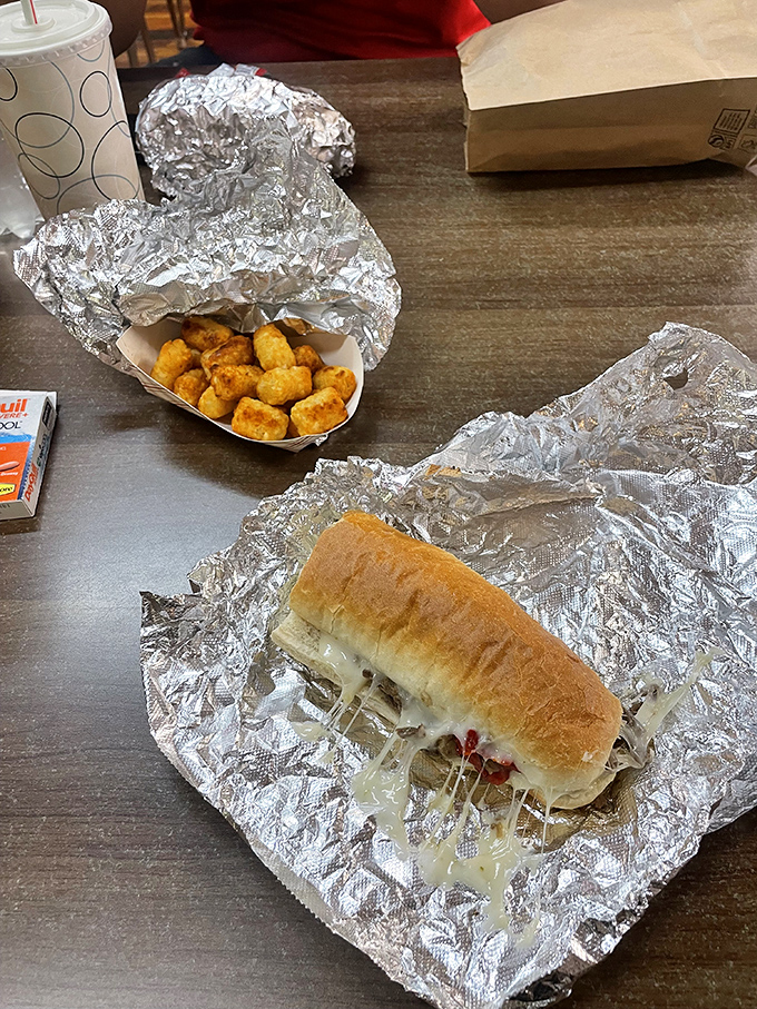 Sandwich Meal: Melty cheese stretches dramatically from this honest sandwich, accompanied by golden tater tots that put fancy fries to shame.