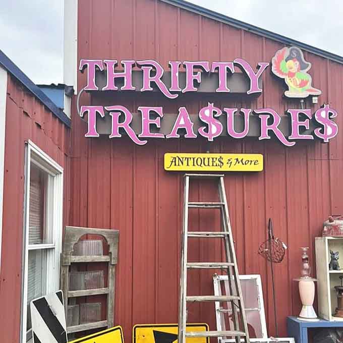 The bold pink "Thrifty Treasures" sign promises adventures in bargain hunting, while ladders and vintage windows lean casually against the building.