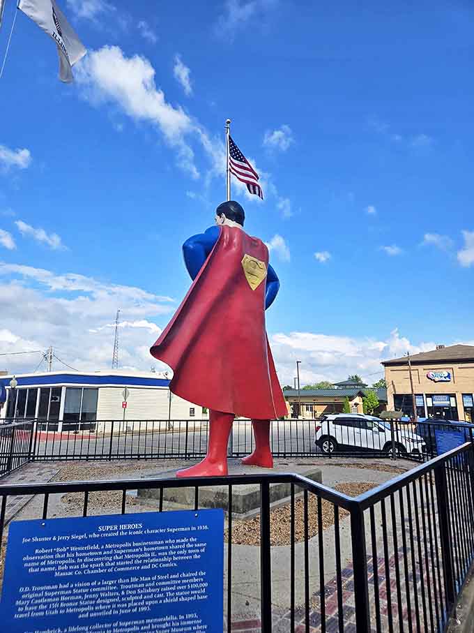 Superman watches over Metropolis from behind, his cape flowing dramatically as he stands ready to protect this charming Illinois town.
