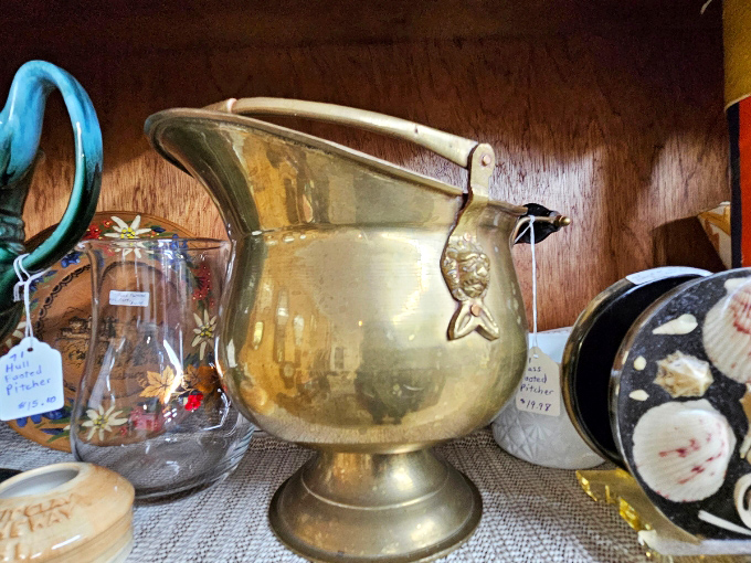 This vintage brass coal scuttle didn't just hold fuel &ndash; it held the warmth of family gatherings, now transformed from household necessity to decorative conversation piece.