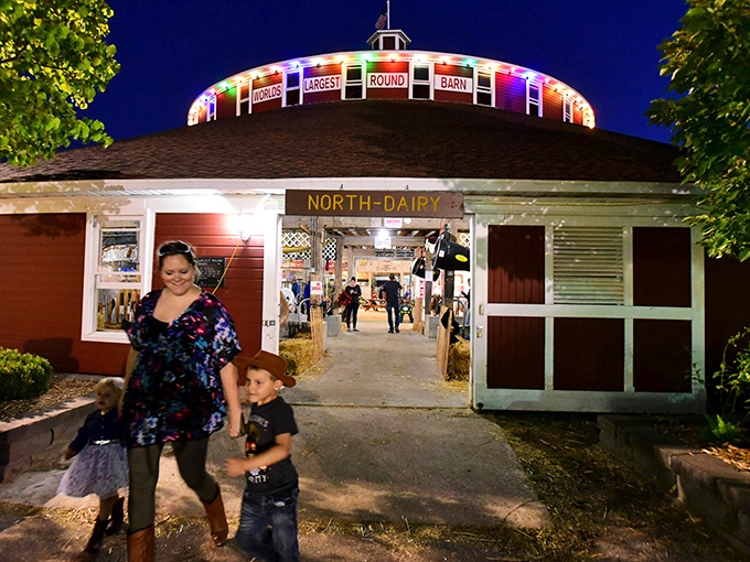 Families explore the grounds during a community event, the barn serving as both backdrop and main attraction.