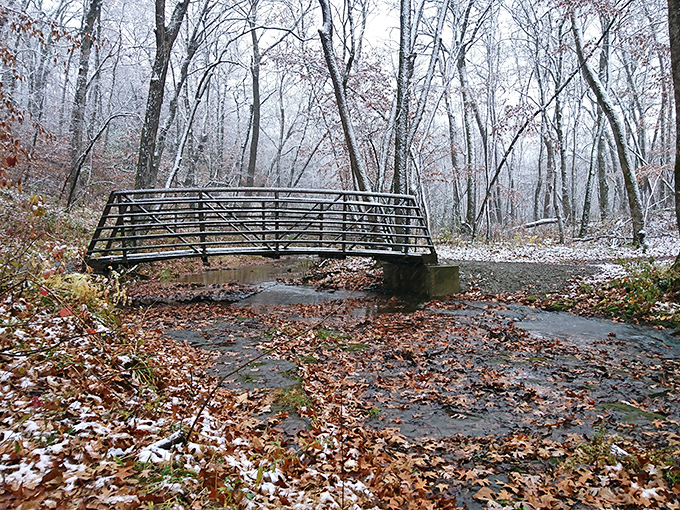 The winter bridge stands sentinel over icy waters, connecting not just shores but visitors to this frozen fairytale.