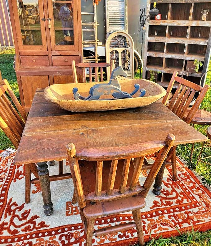 Wooden Dining Set: A rustic farmhouse table surrounded by mismatched wooden chairs creates the perfect setting for future family gatherings and memory-making meals.