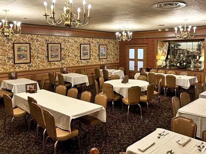 Another angle reveals the restaurant's warm, traditional aesthetic&mdash;where white tablecloths and wood paneling create the perfect backdrop for memorable meals.