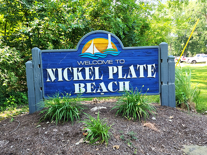 The cheerful welcome sign greets visitors with its nautical theme, promising lakeside adventures ahead.