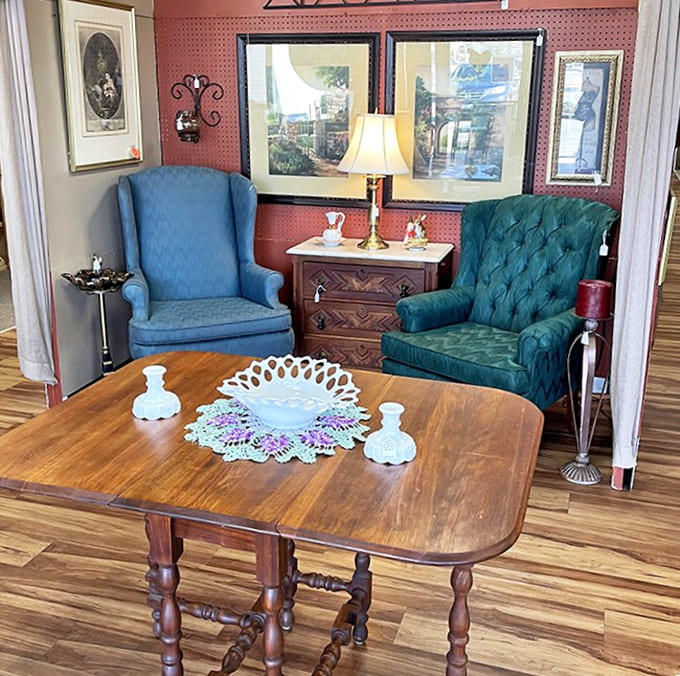 Vintage chairs flank a classic drop-leaf table, creating a cozy conversation nook that's just waiting for afternoon tea and good company.