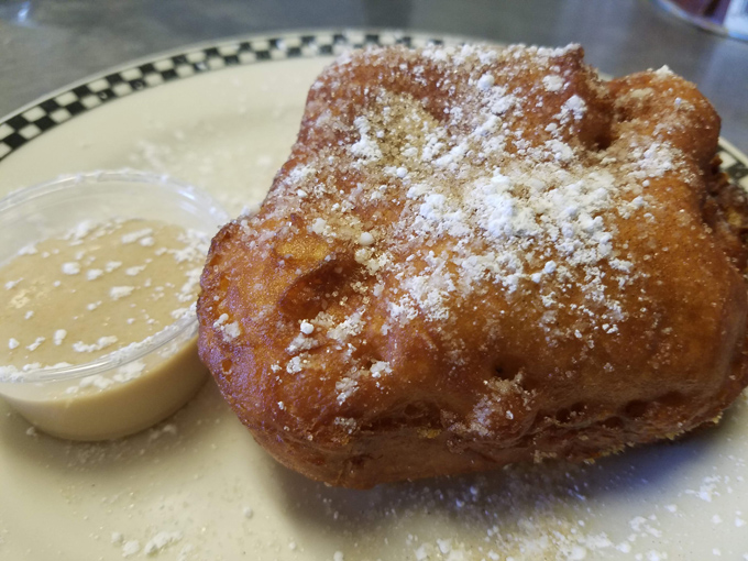Fried dough dusted with powdered sugar &ndash; crispy exterior giving way to a tender inside that's worth every delicious calorie.