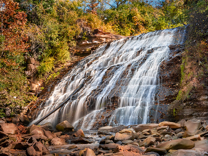 Autumn transforms Mill Creek Falls into a masterpiece of contrasts &ndash; white water against fiery foliage and ancient rock.