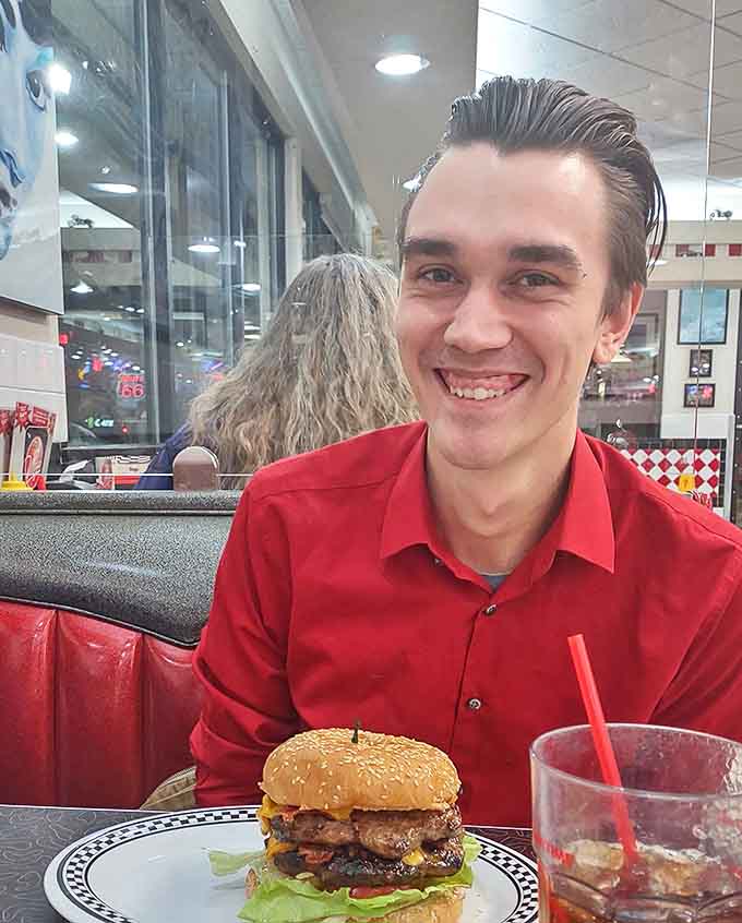 Empty tables waiting for stories to unfold, where red vinyl meets chrome in a dance as timeless as the classics playing softly overhead.