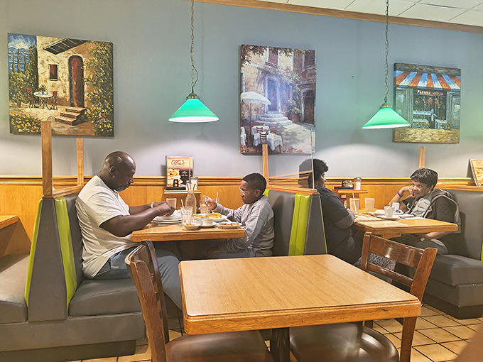Families gather in cozy booths beneath European caf&eacute; paintings, creating their own masterpieces of breakfast memories.