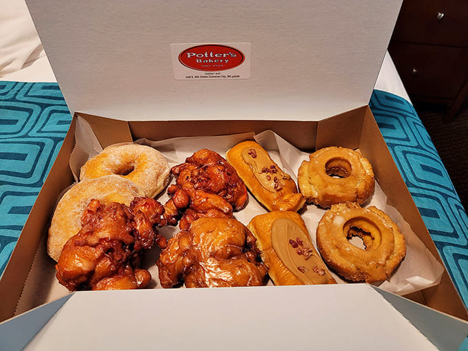 Apple fritters the size of your hand sit next to their donut cousins, all glistening with glaze like they just won some kind of pastry beauty pageant.