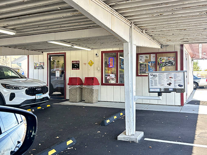 The covered parking area offers shelter from Minnesota weather while preserving the nostalgic drive-in experience that keeps customers coming back.