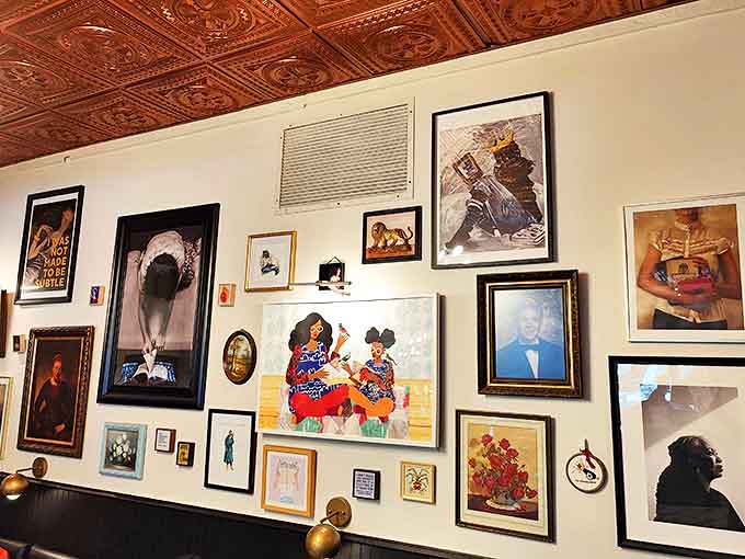 The gallery wall tells visual stories that complement the written ones, creating layers of narrative throughout the welcoming space.