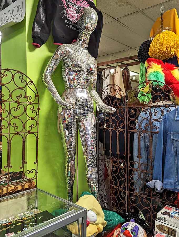 Not your average mannequin, this mirrored disco ball figure throws light fragments across the room while modeling vintage threads with silent sparkle.