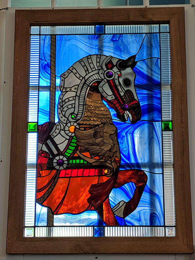 Modern meets traditional in this stunning stained glass carousel horse, its electric blue background making the mechanical steed appear to gallop through the sky.