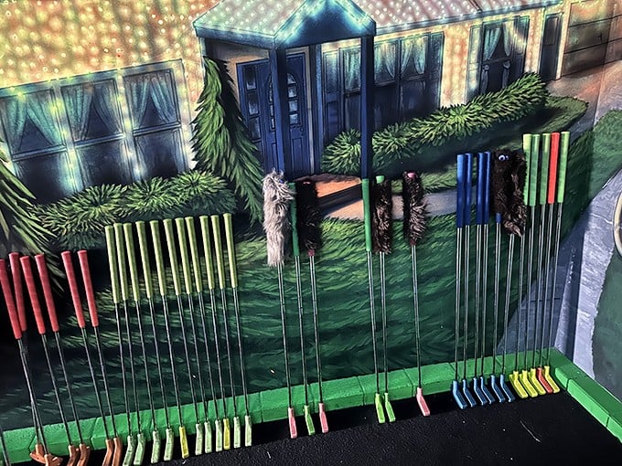 Choose your weapon wisely, earthling! These colorful putters stand ready for your mini-golf mission against the backdrop of an alien landscape.