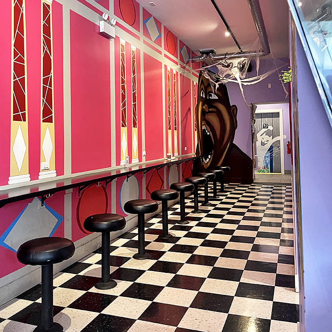 Pinball machines line the walls, their lights creating a magical glow that transforms ordinary evenings into extraordinary adventures.