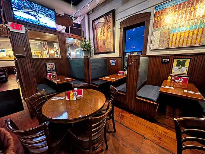 Wooden booths create intimate islands in the convivial sea of tavern life, where strangers become friends over shared appreciation of good food.