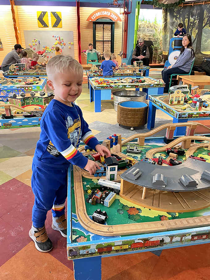 Joy radiates from this young engineer's face as he navigates his locomotive through a world built to his specifications, learning physics disguised as pure fun.
