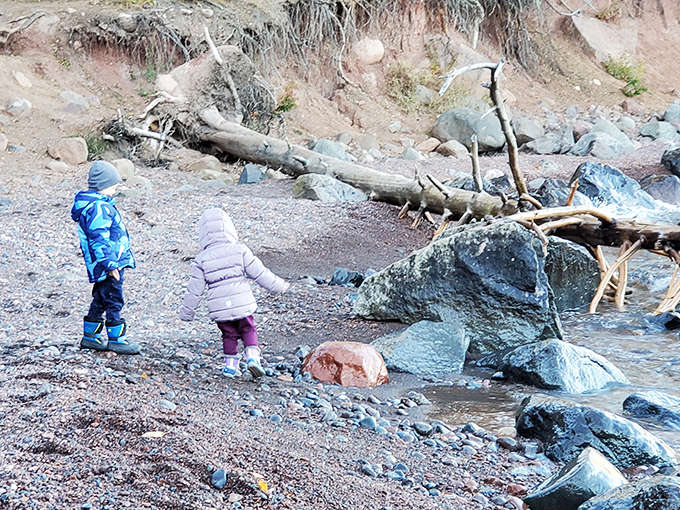 Little explorers discover big adventures along the shore, where every colorful stone and driftwood piece becomes treasure.