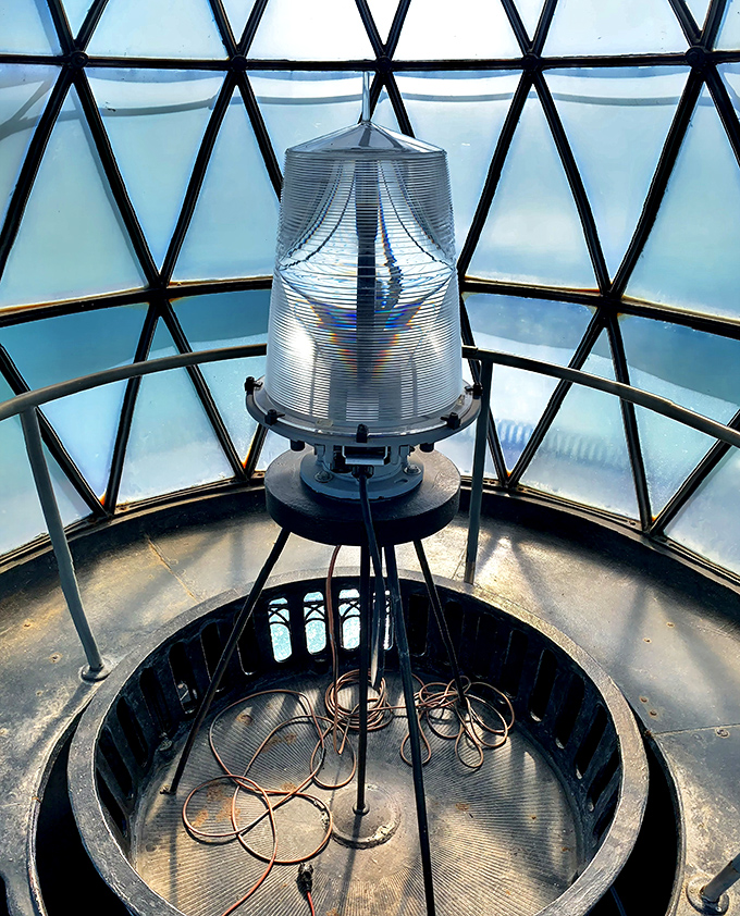 The lighthouse's beating heart – its lantern room – where modern solar technology has replaced the original oil lamps and Fresnel lens.