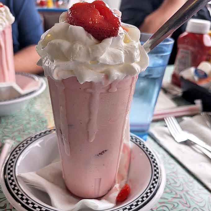 A pink cloud of nostalgia topped with whipped cream and a cherry, thick enough for spoon-standing but smooth enough for straw-sipping bliss.