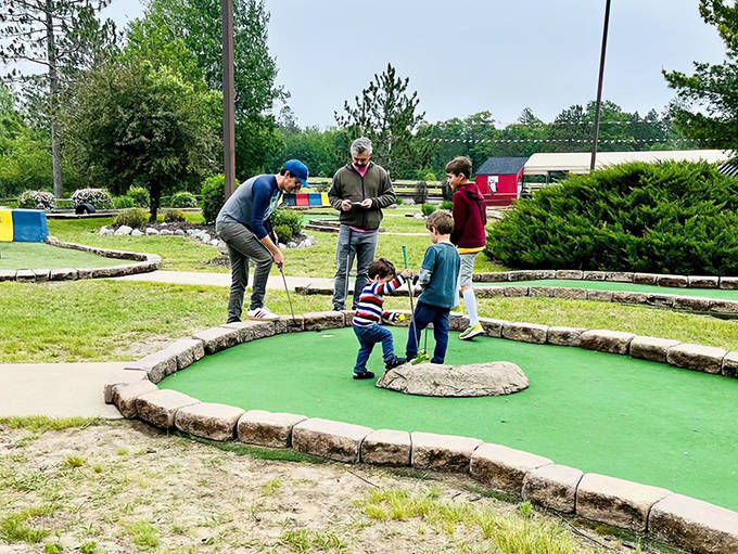 Family putting prowess on display at the mini-golf course, where friendly competition and laughter go hand-in-hand on the green.