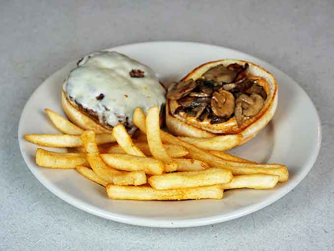 This mushroom burger with its melty cheese blanket and golden fries isn't just lunch&mdash;it's therapy on a plate.