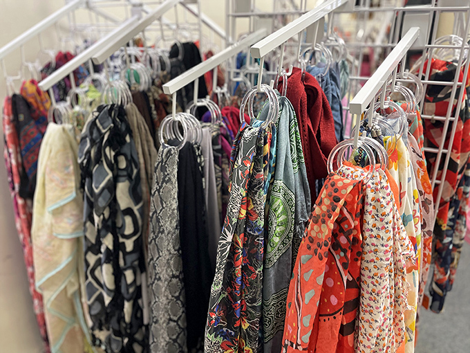 Silk scarves in every imaginable pattern hang like exotic birds, ready to transform even the simplest outfit.