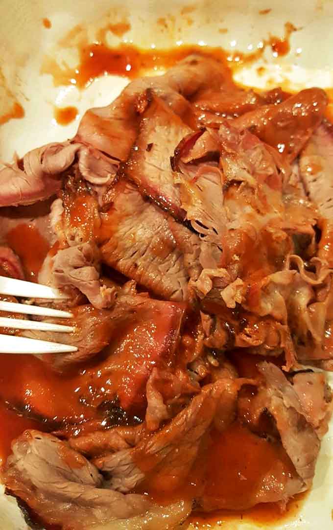 Pulled pork that surrenders at the touch of a fork, bathed in just enough sauce to complement without overwhelming. Each strand tells a story of patience and skill.