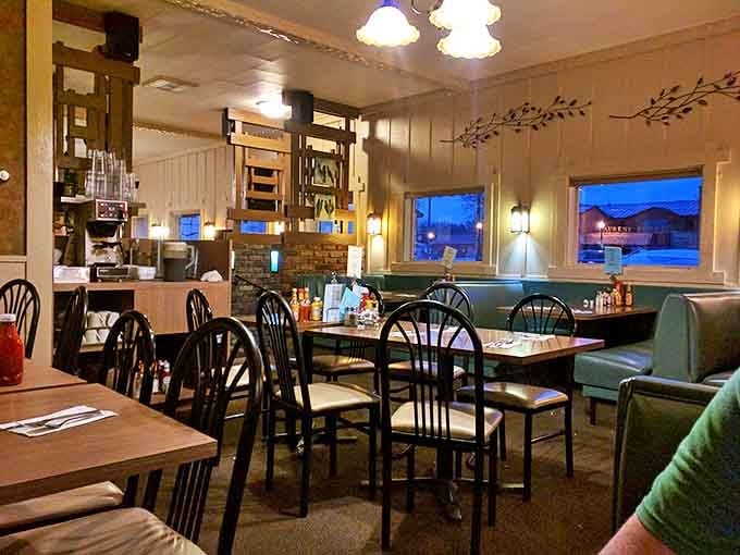 Evening light filters through windows, casting a warm glow across wooden tables and teal booths where countless family stories have been shared.