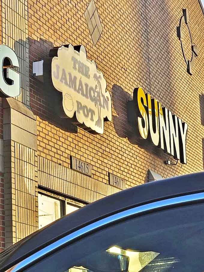 Even in daylight, the restaurant's sign stands out against the brick backdrop &ndash; a beacon for those seeking authentic Caribbean cuisine.
