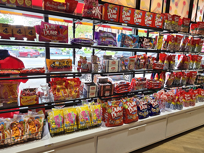Shelves bursting with colorful candy packages create a rainbow of temptation, with Dum Dums and other Spangler classics arranged in mouthwatering displays.
