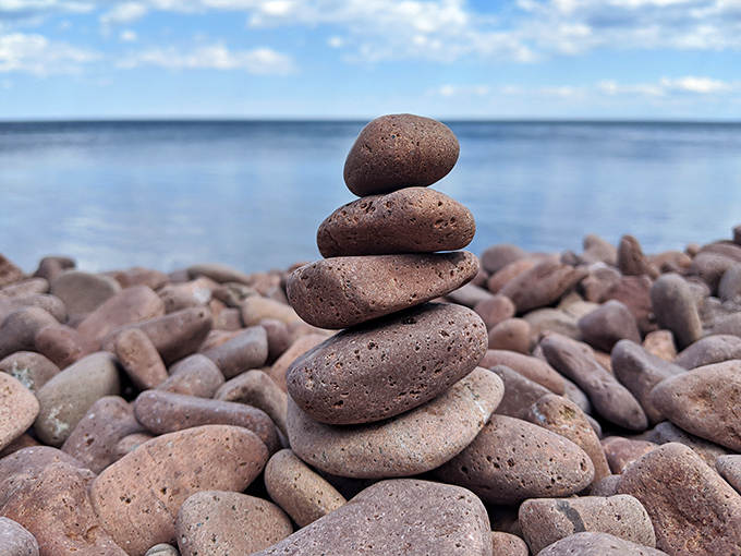 Someone's temporary meditation &ndash; stacked stones create a moment of balance and mindfulness against the vast lake backdrop.