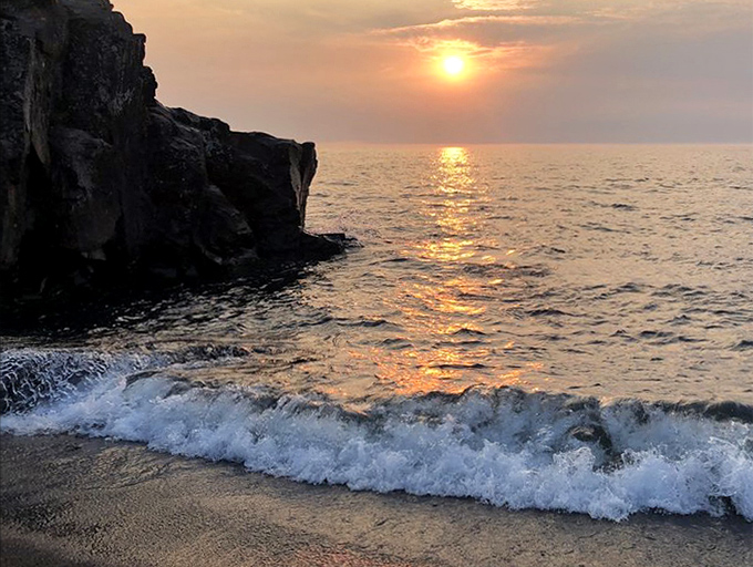 When day surrenders to evening, Black Beach transforms into a front-row seat for nature's most spectacular light show.