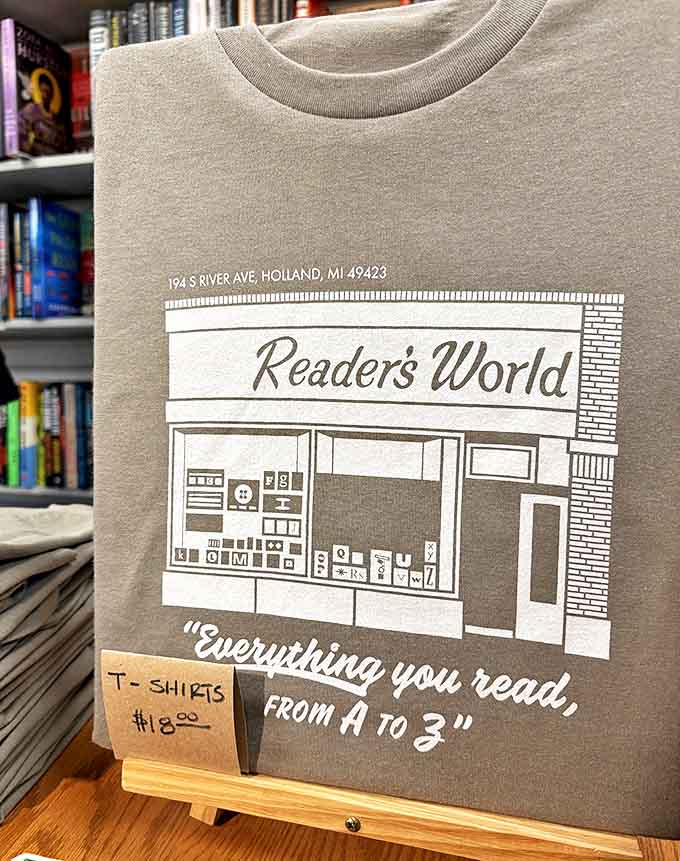 A simple gray t-shirt becomes a badge of honor for book lovers, proudly declaring Readers World's promise: "Everything you read, from A to Z."