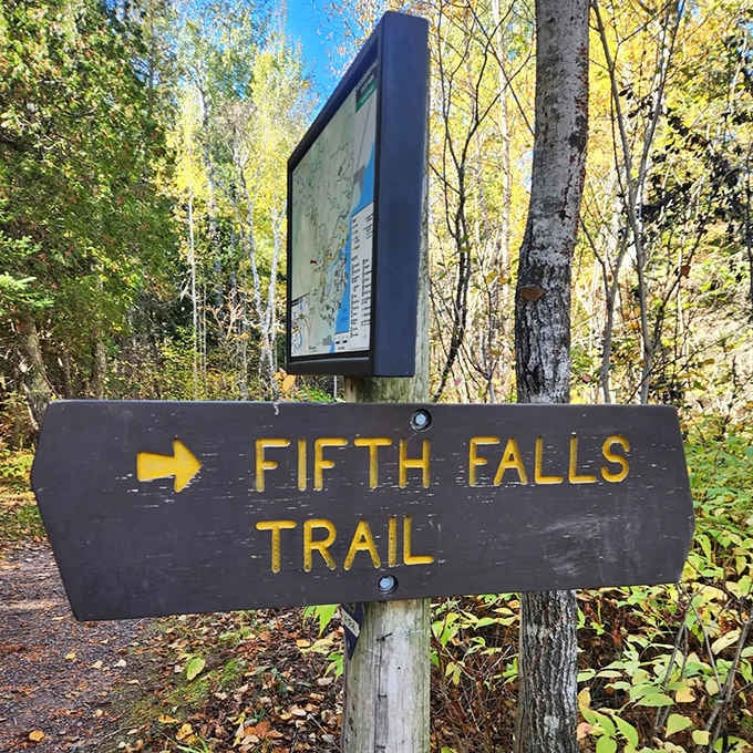 The Fifth Falls Trail sign stands as a friendly sentinel, pointing adventurers toward one of Minnesota's most rewarding short hiking experiences.