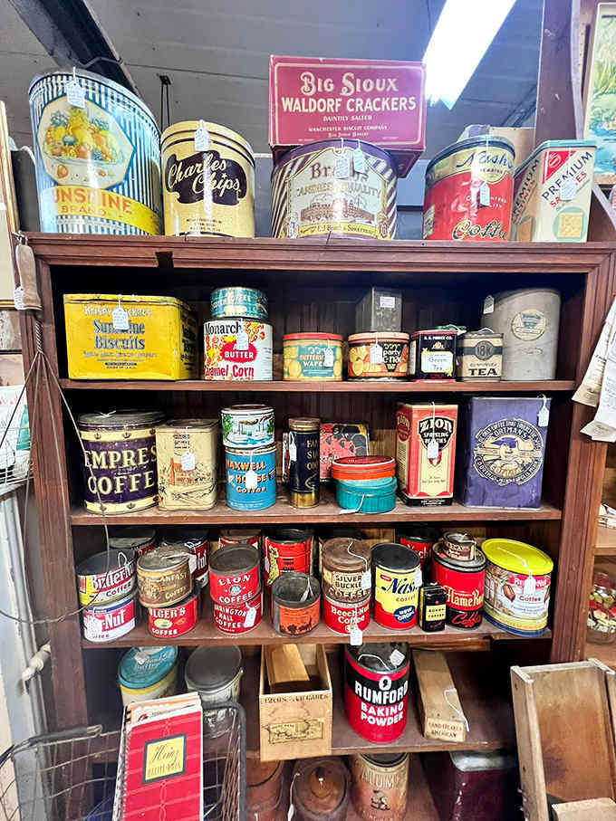 A colorful regiment of vintage tins marches across wooden shelves, their vibrant graphics and bold lettering showcasing the golden age of American advertising.