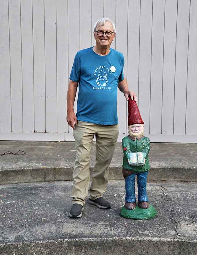 A local resident proudly displays his contribution to the town's gnome population, showcasing the community spirit behind the phenomenon.