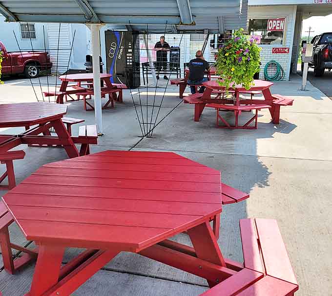 Cherry-red picnic tables invite diners to enjoy their feast outdoors, where food somehow tastes better under the open sky.
