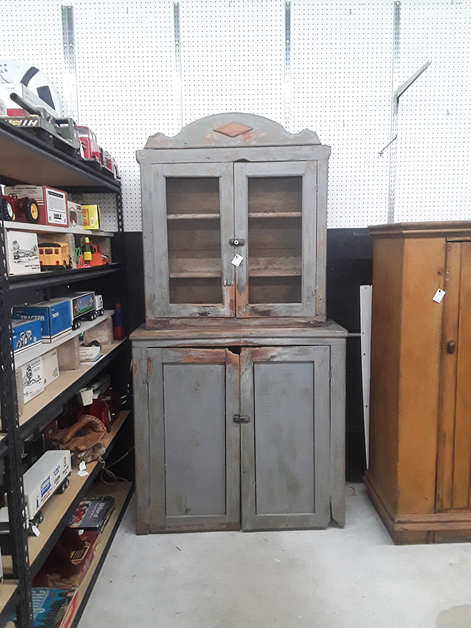 This weathered gray hutch has witnessed decades of family meals and now waits patiently for its next chapter.
