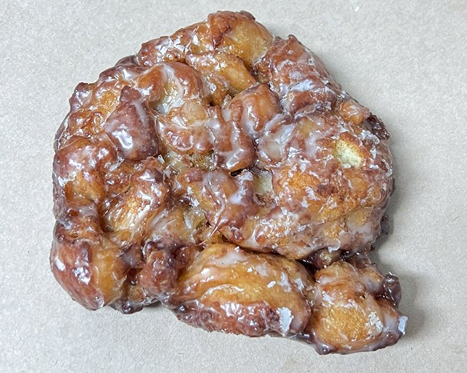 The legendary apple fritter &ndash; an irregular masterpiece of fried dough, tender apple chunks, and glaze that shatters like candy with each heavenly bite.