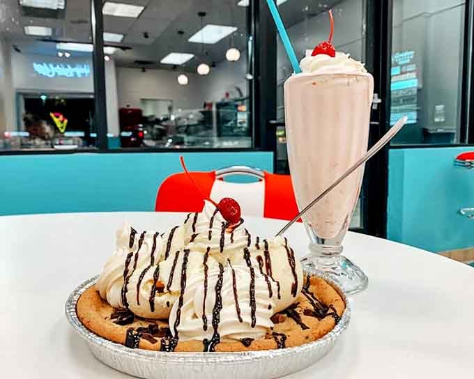 The ultimate power couple: a towering banana split alongside a shake that requires serious straw commitment and zero distractions.