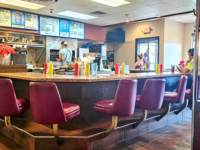 The counter view &ndash; where burger magic happens over glowing charcoal, a culinary fireworks show for hungry eyes.
