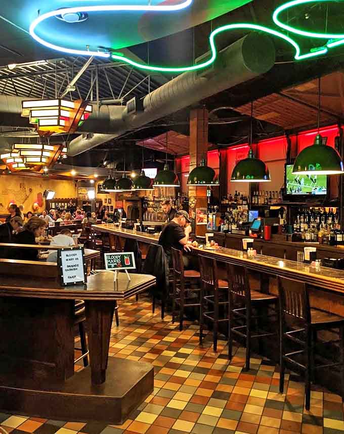 The bar area glows with neon promise&mdash;where sports on TV and cold drinks create the perfect backdrop for pizza appreciation.