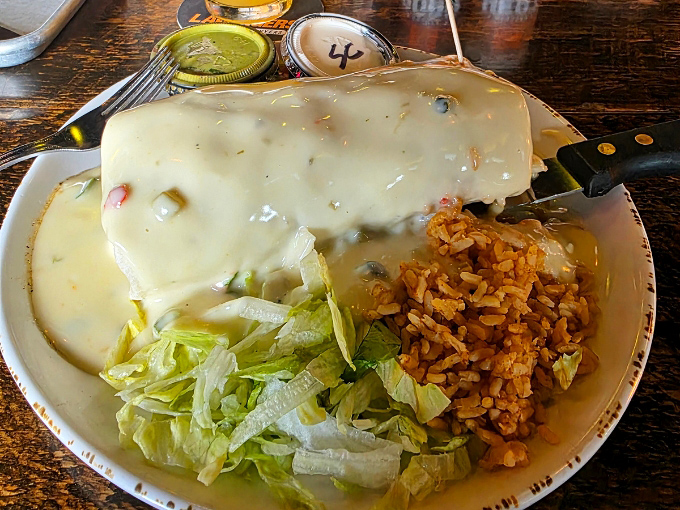 Big Bore's smothered burrito is a Minnesota comfort food challenge. That creamy queso sauce is waiting for your hungry fork!