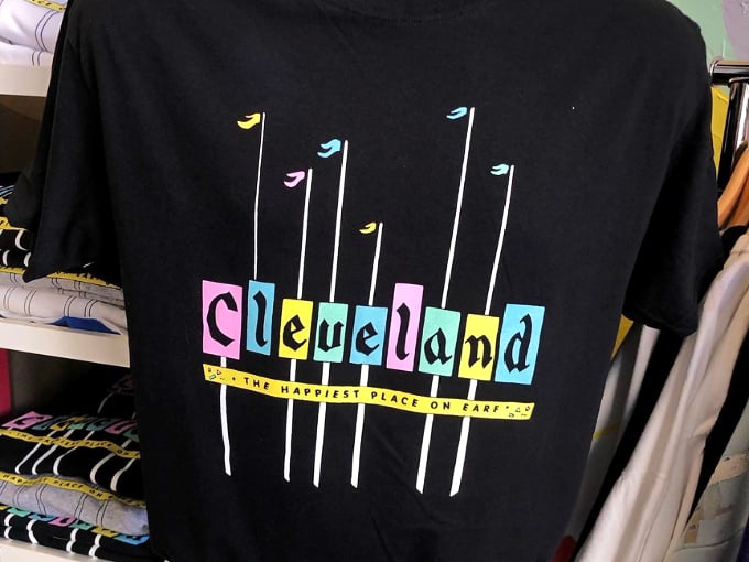 "Cleveland: The Happiest Place on Earf" proclaims this vintage-inspired tee, combining civic pride with the kind of typography that defined the 90s.