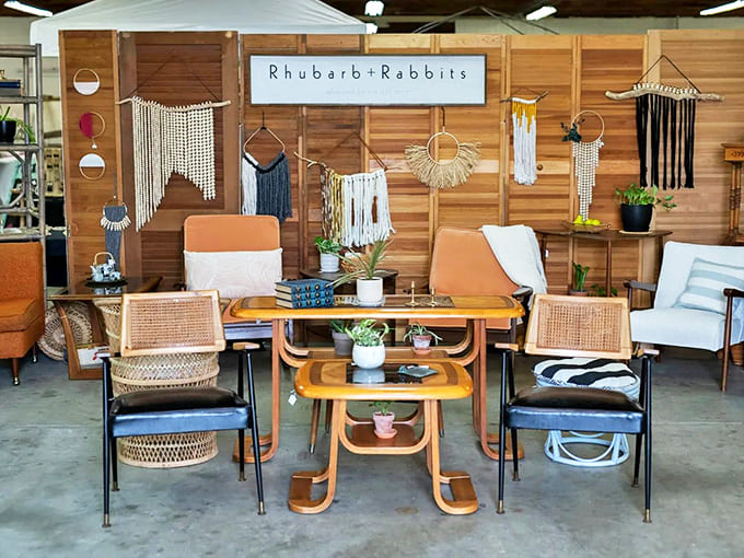 Bohemian-modern Decor: Macram&eacute; wall hangings frame mid-century furniture in this Rhubarb+Rabbits display, blending bohemian textures with clean modern lines.