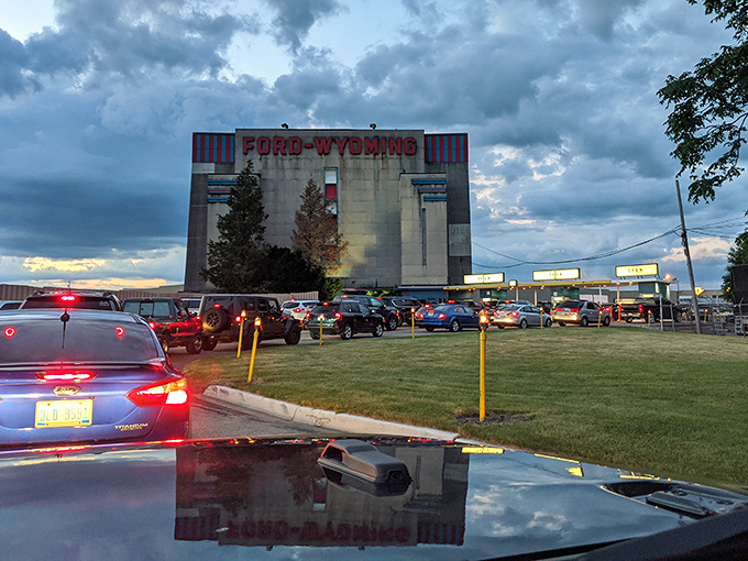 Cars arrange themselves in neat rows, each finding the perfect angle for an unobstructed view of cinematic magic.